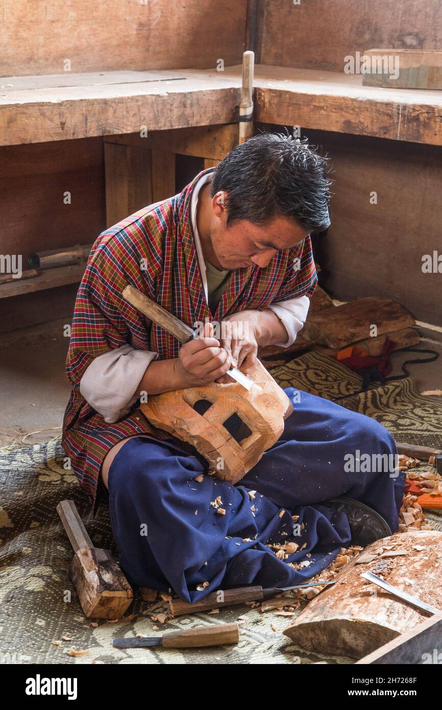 A wood carver making a mask from wood in the National School for the ...