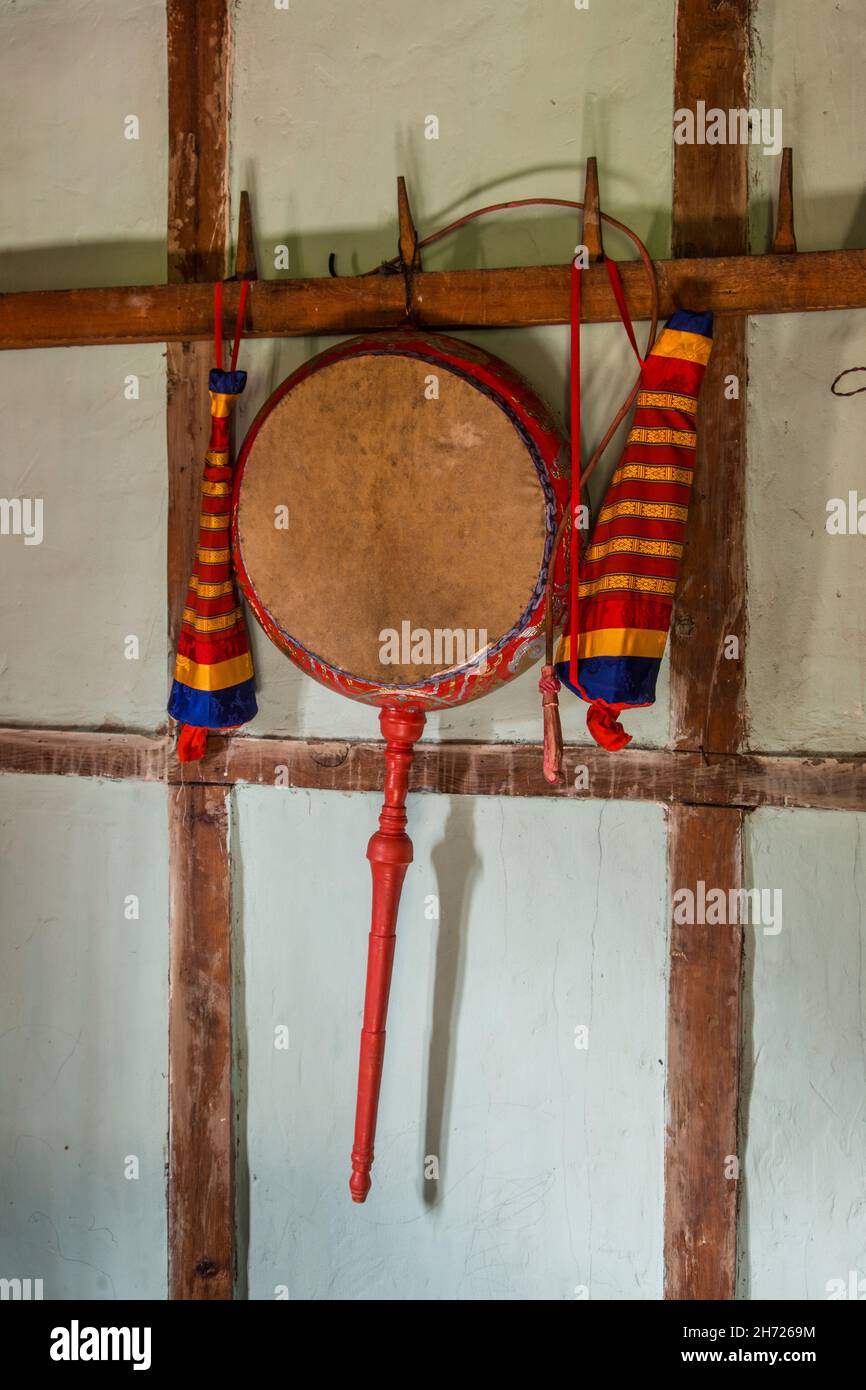 A Tibetan ceremonial Nga drum and dungchen horns in silk cases on a ...