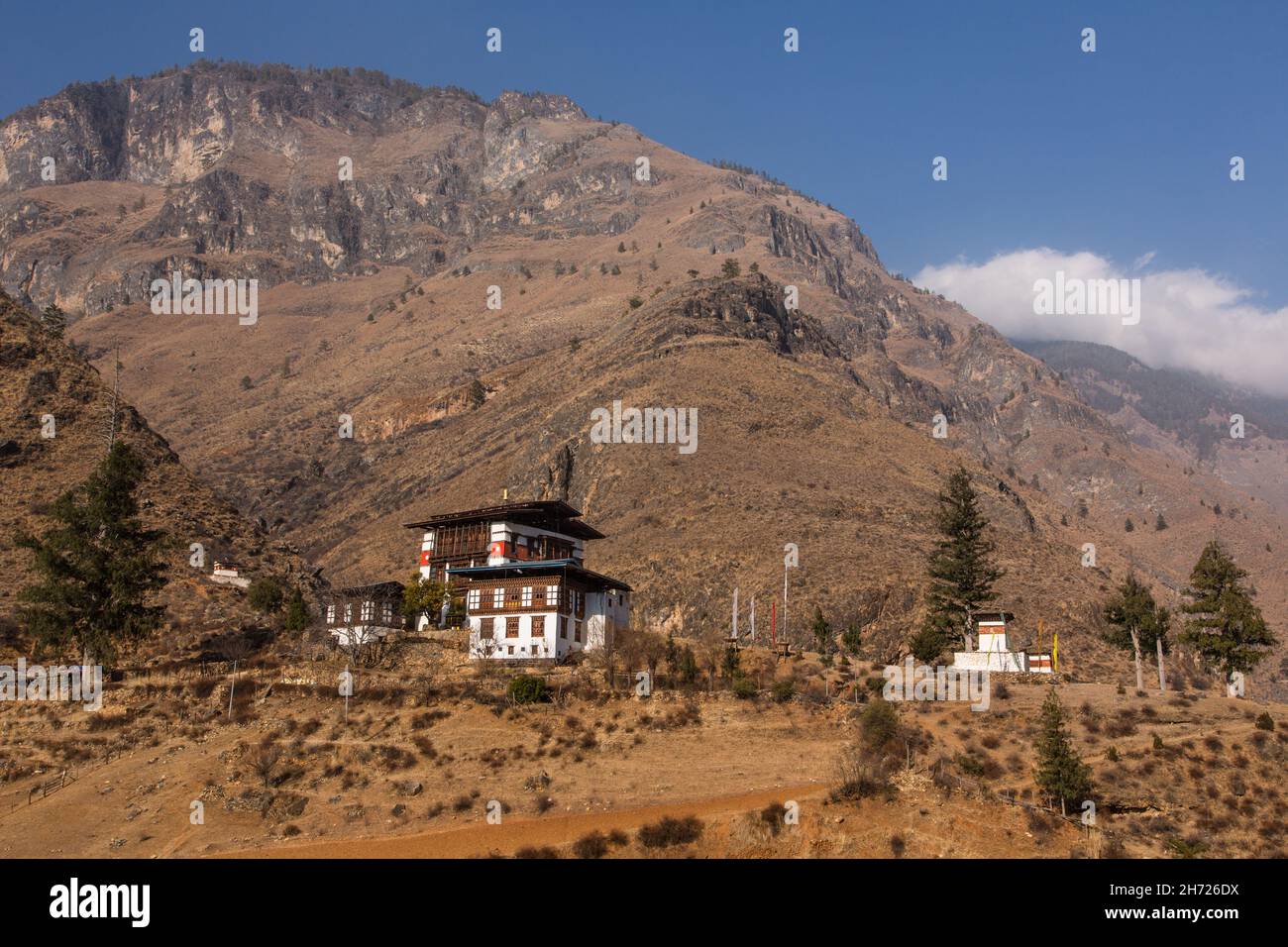 The Tamchhog Lhakhang Buddhist temple, farm house and red-stripe ...