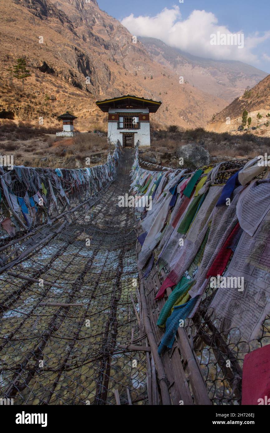 Prayer flags line the iron chain bridge over the Paro Chhu River near ...