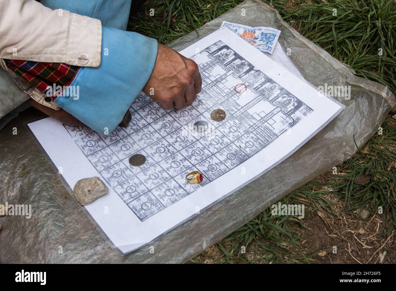 A man placing bets on paper gambling game in Thimphu, Bhutan Stock ...