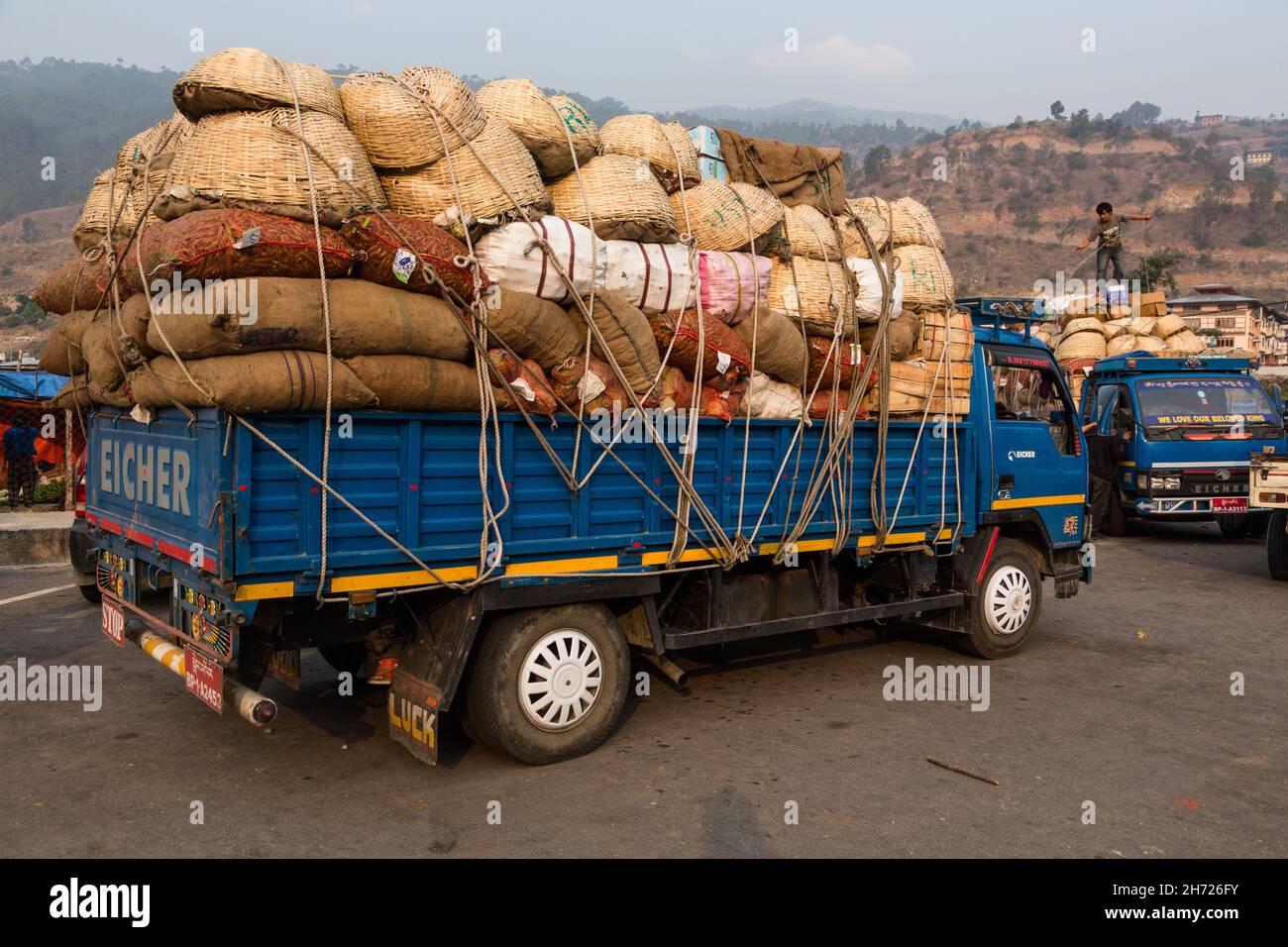 An overloaded goods hauler truck loaded with produce for the outdoor ...