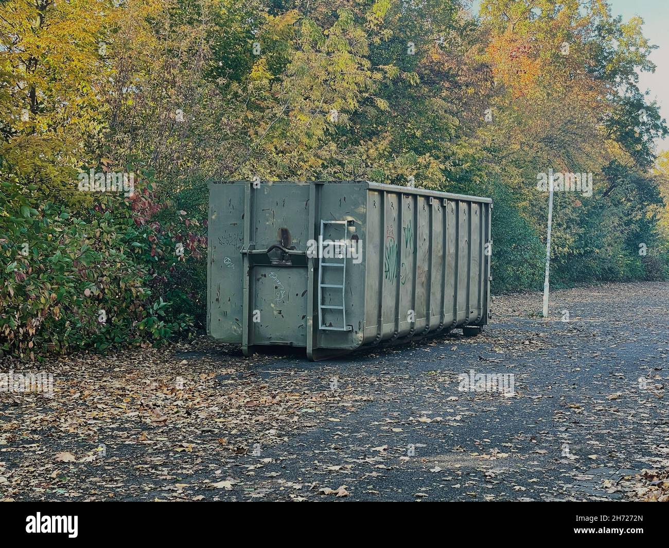 Large rubbish container is parked in a car park Stock Photo - Alamy