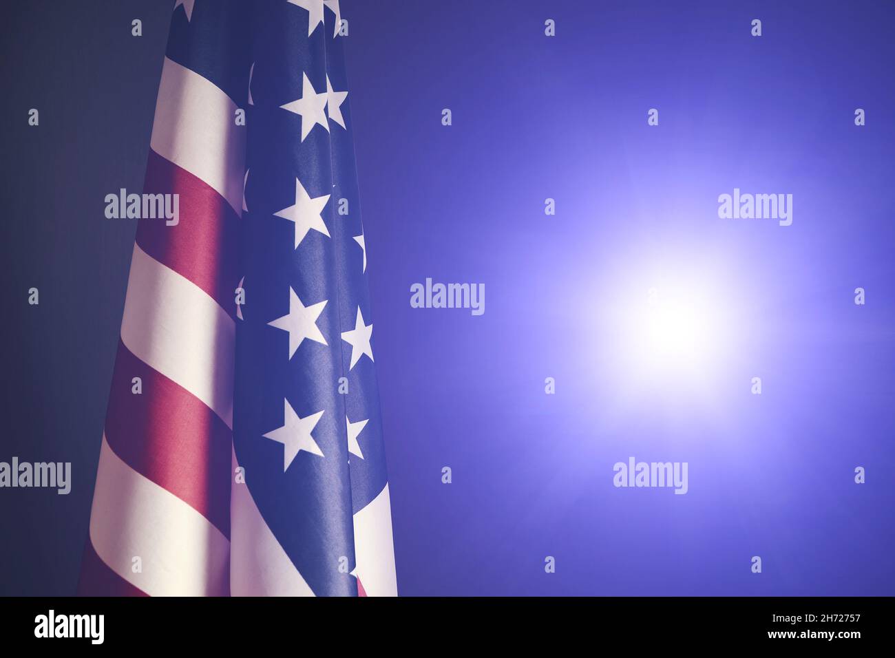 Flag of the United States of America against background bright light ...