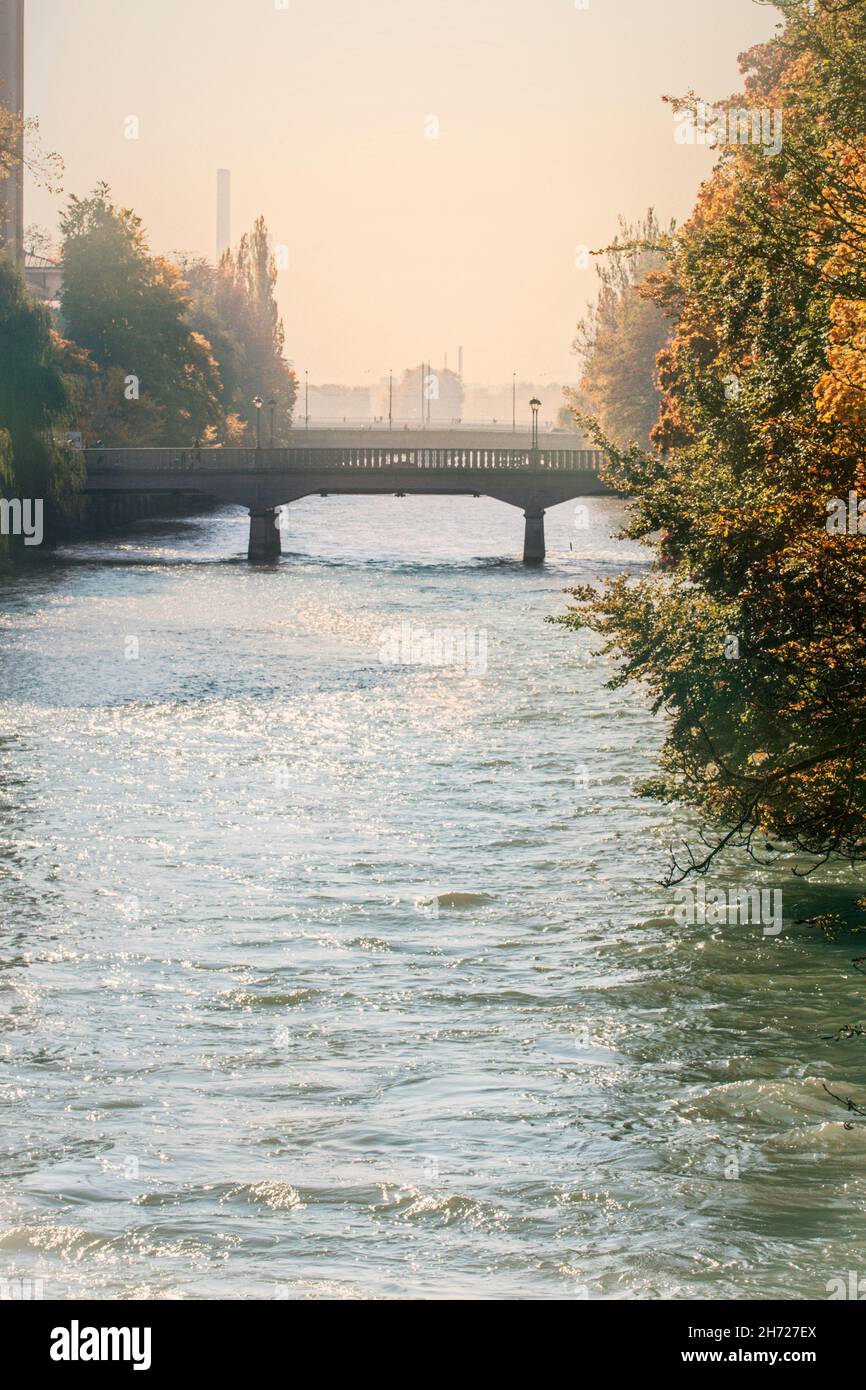 Munich, Bosch bridge on Isar river autumnal view in a sunny foggy day ...