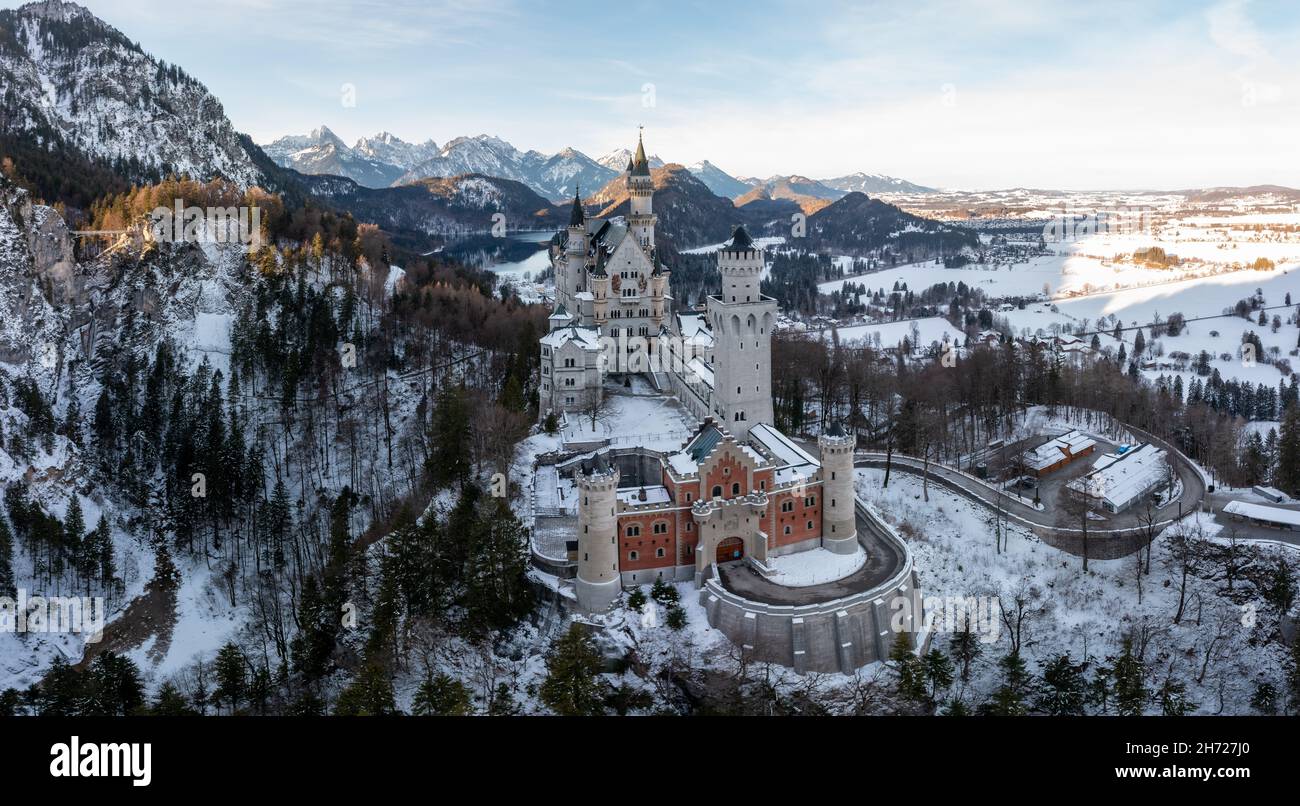 Scenic shot of the Neuschwanstein Castle in Germany surrounded by snowy ...