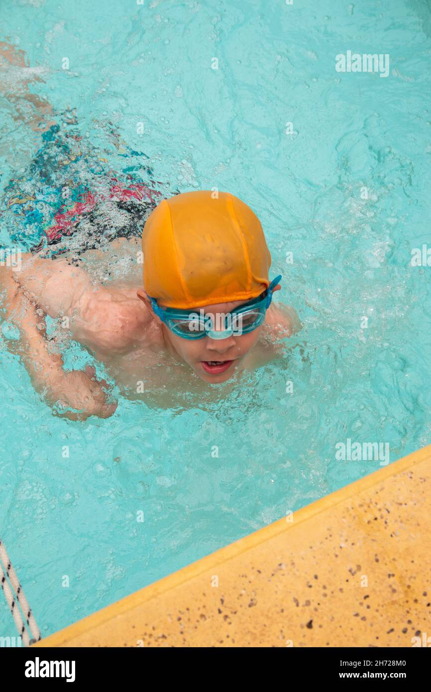 Overhead shot of a Caucasian kid swimming in the pool Stock Photo - Alamy