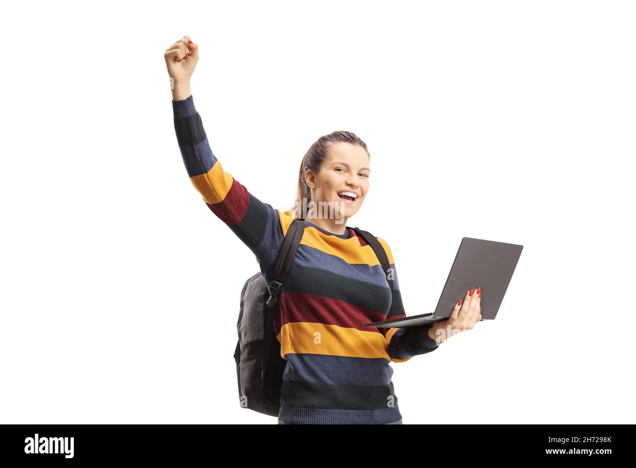 Happy female student holding a laptop and raising arm isolated on white ...