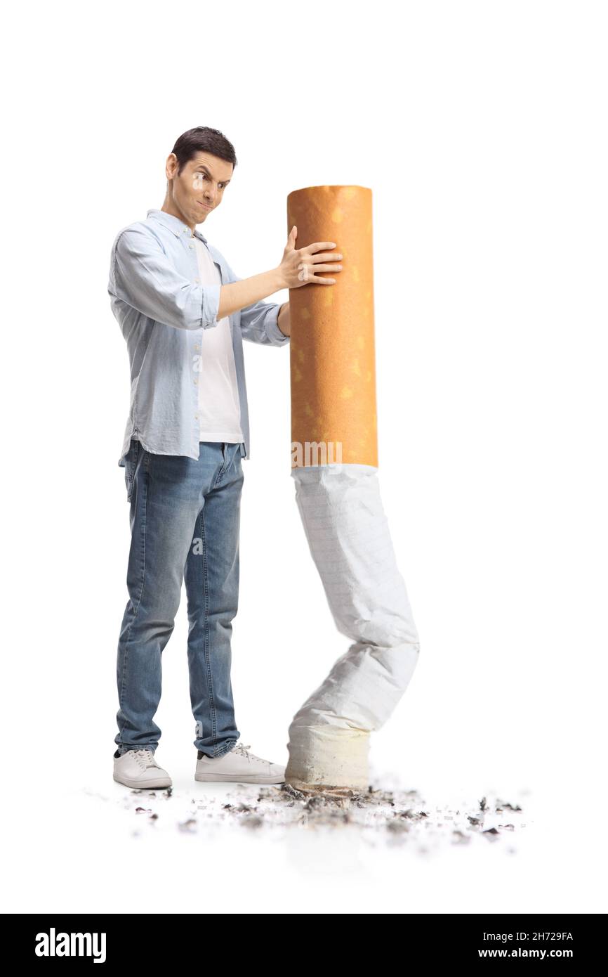 Angry young man putting off a big cigarette isolated on white ...