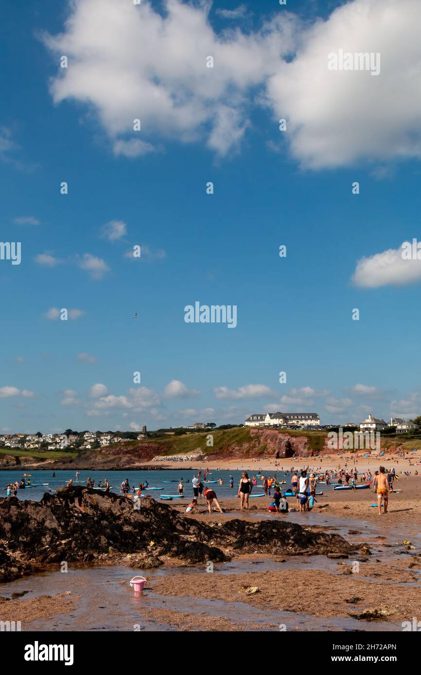 Beachgoers enjoy the sunny weather and blue sky at South Milton Sand ...