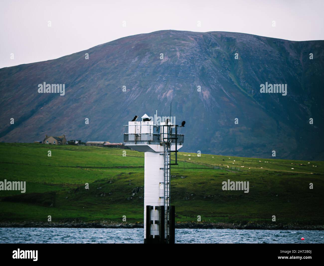 Industrial lighthouse in the sea on a cloudy day Stock Photo - Alamy