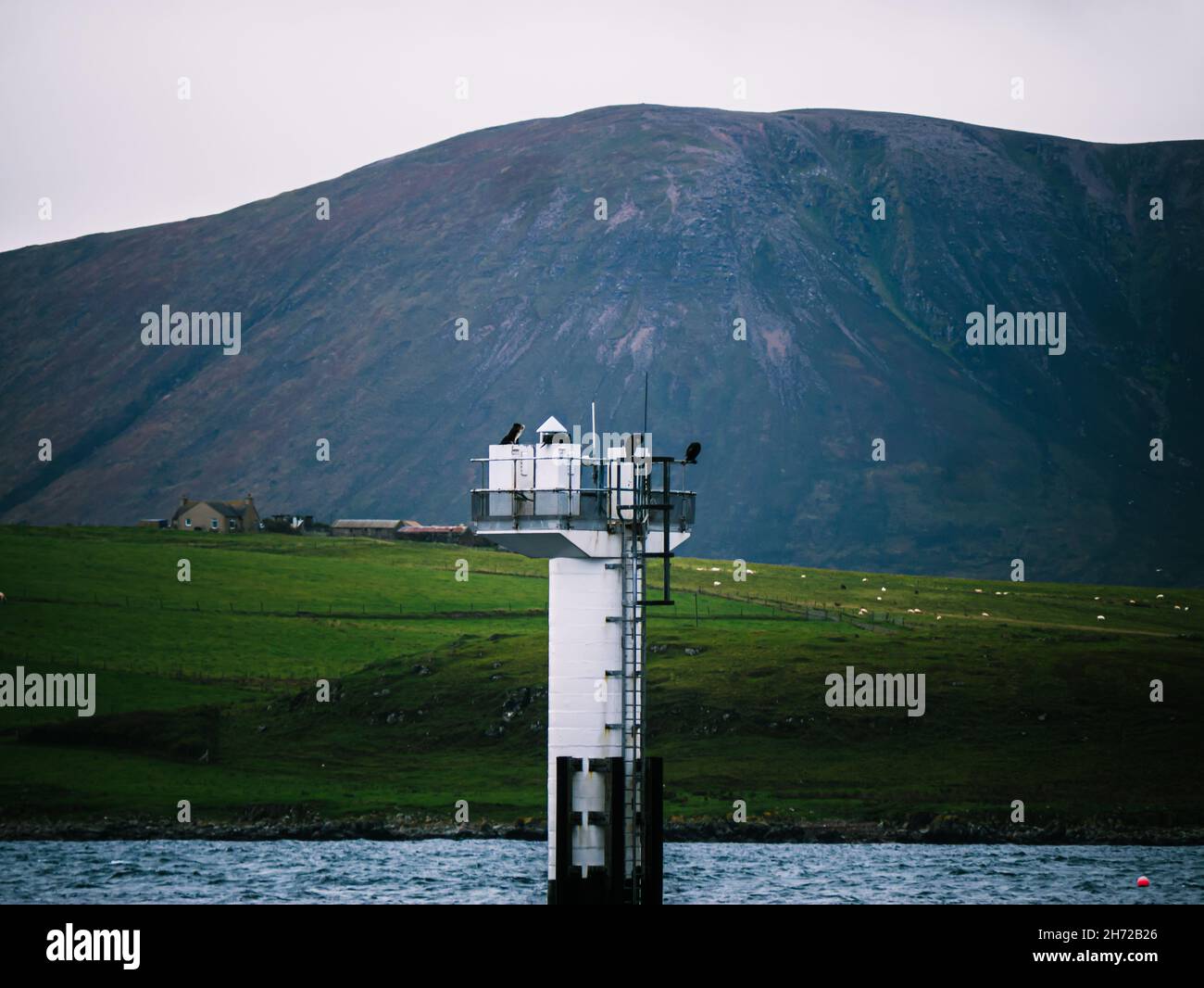 Industrial lighthouse in the sea on a cloudy day Stock Photo - Alamy
