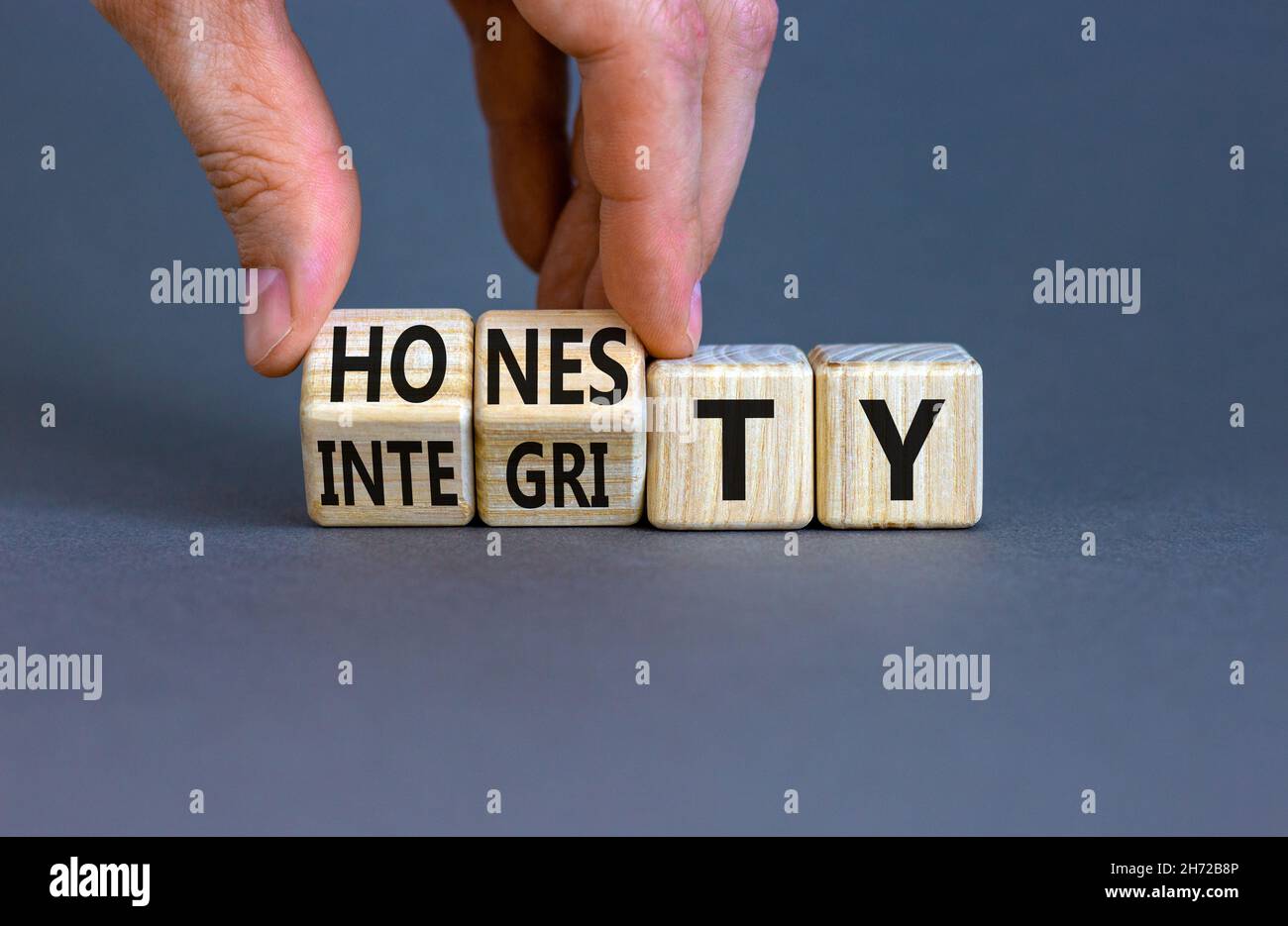 Honesty and integrity symbol. Businessman turns wooden cubes and ...