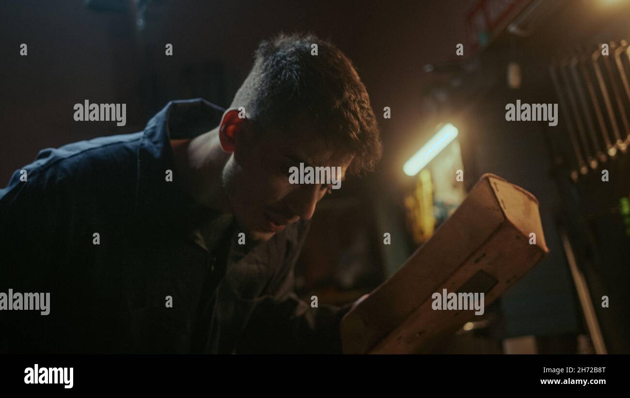 Blacksmith handsome man with welding shield using welding machine for ...