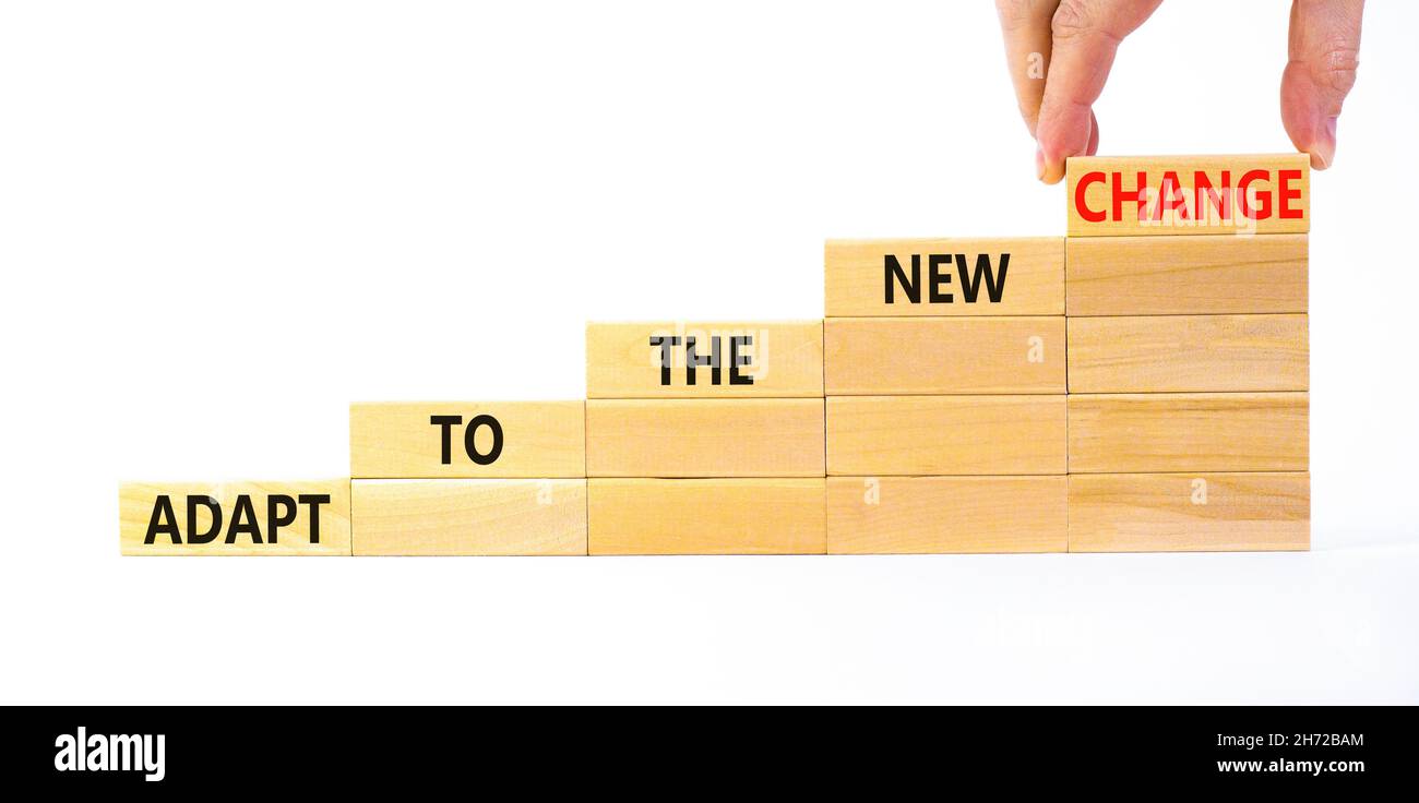 Adapt to the new change symbol. Wooden blocks with words Adapt to the ...