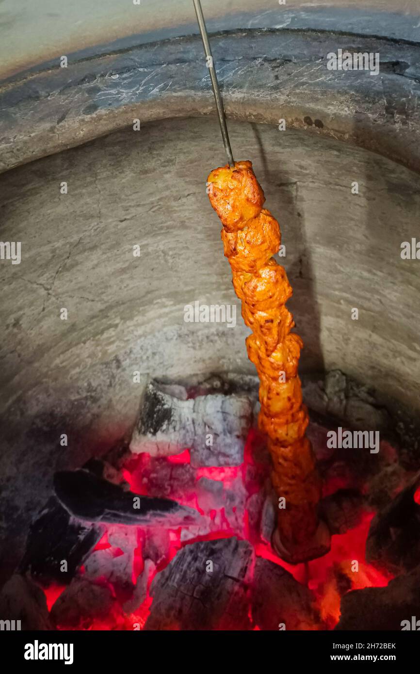 Marinated fresh meat getting cooked in the tandoor Stock Photo - Alamy
