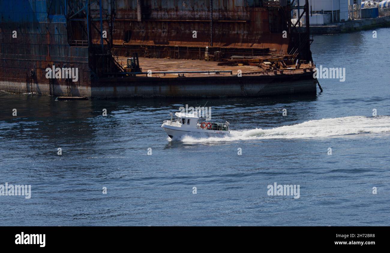 Speed boat passing floating dry dock in port of Bergen, Norway Stock ...
