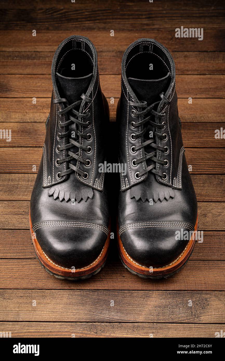 Hand crafted black leather high boots Stock Photo - Alamy