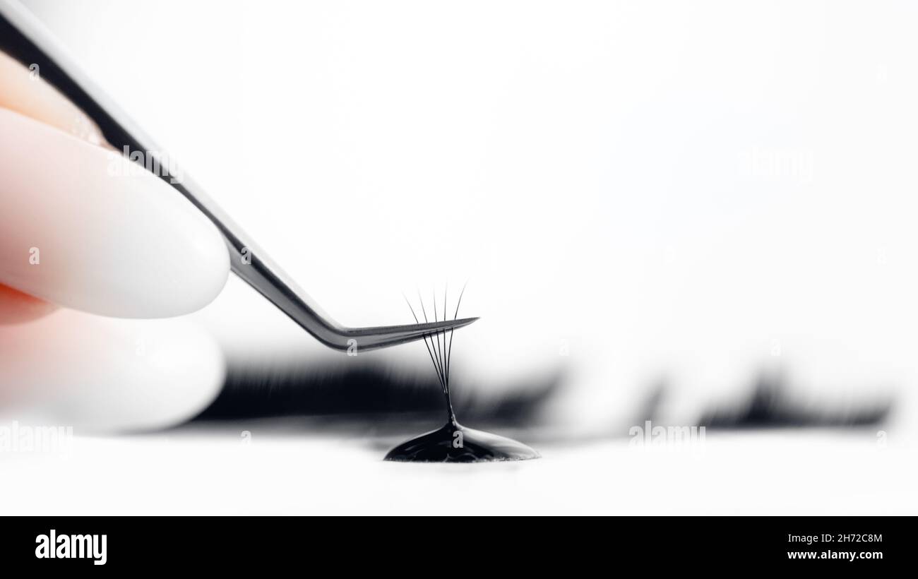 Banner Master of artificial eyelashes forms bundle in drop glue with ...