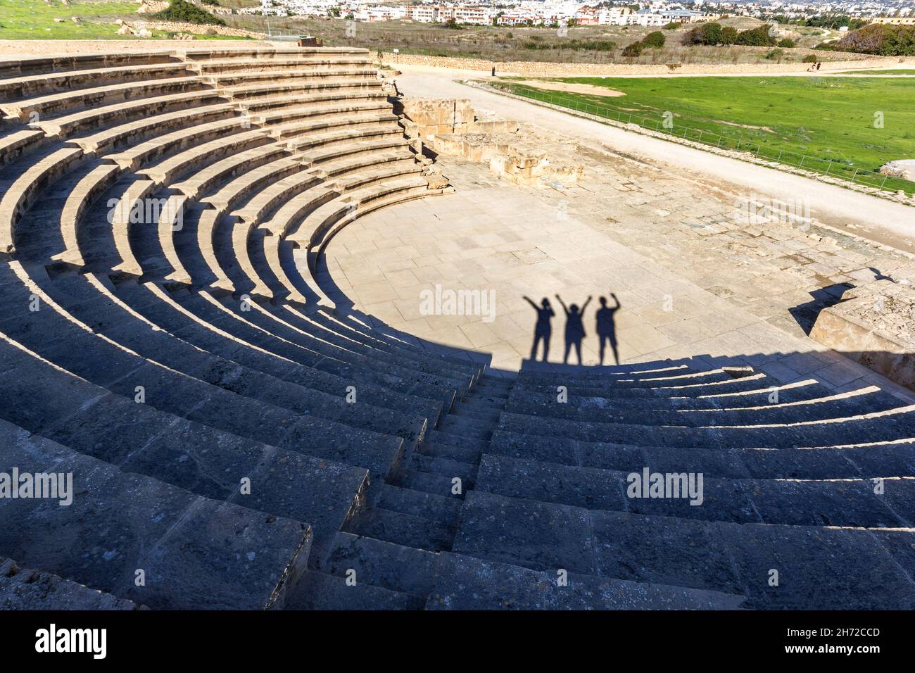 Ancient amphitheater with visitors shadow at Paphos Archaeological Park ...