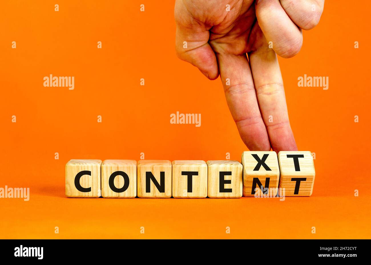 Content and context symbol. Businessman turns wooden cubes and changes ...