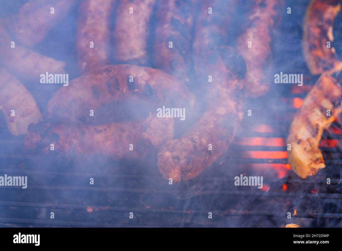 Grilling sausages on barbecue grill. Delicious sausages on charcoal ...