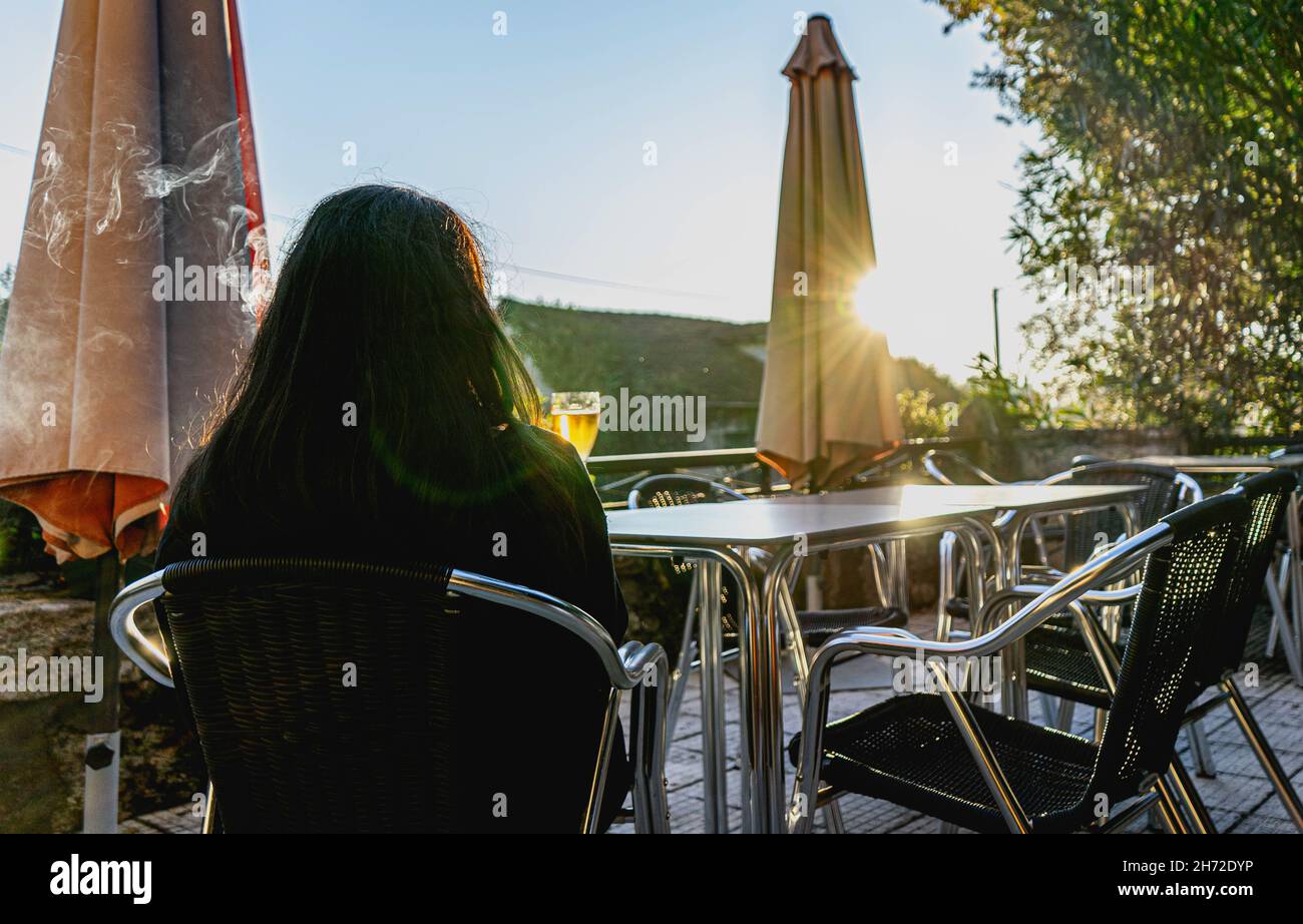 person sitting on a bar terrace Stock Photo - Alamy