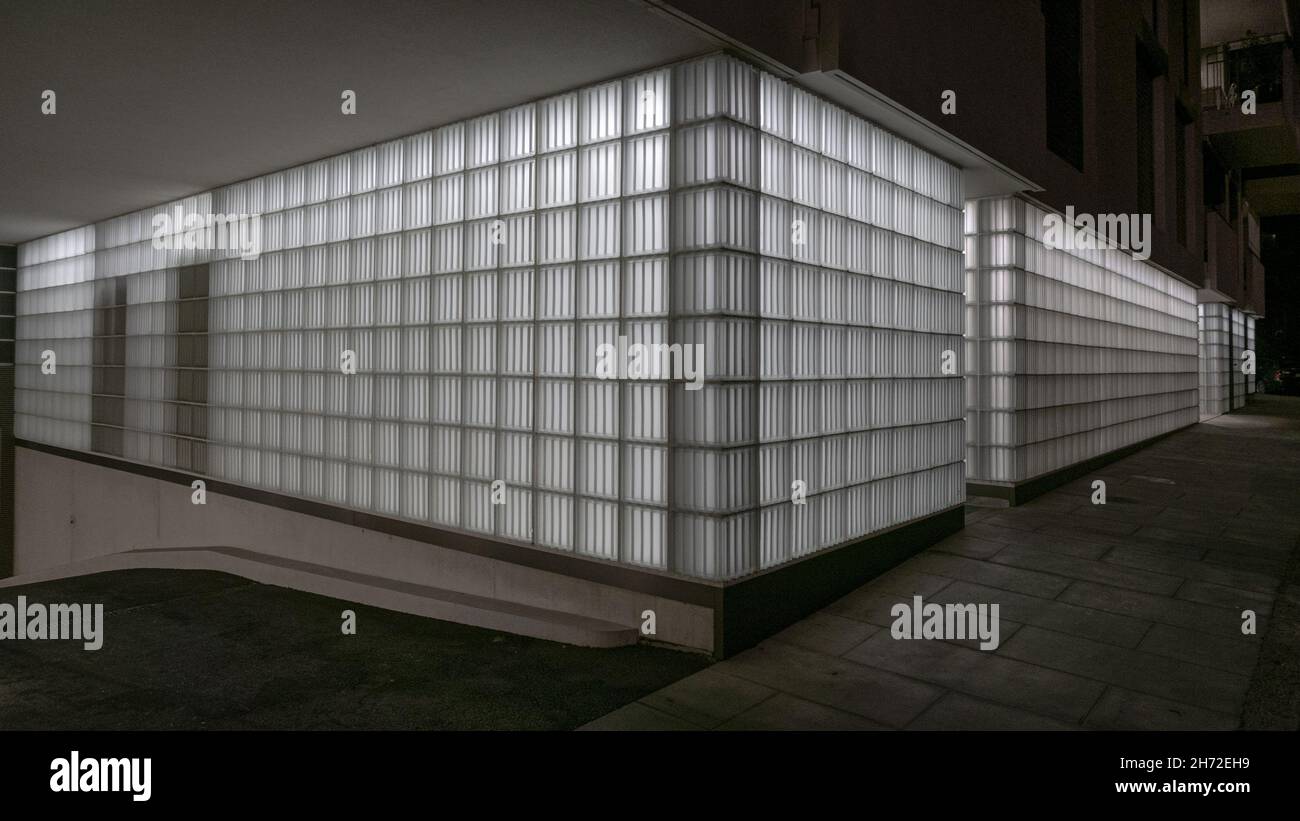 Wall made of illuminated glass squares at night Stock Photo - Alamy