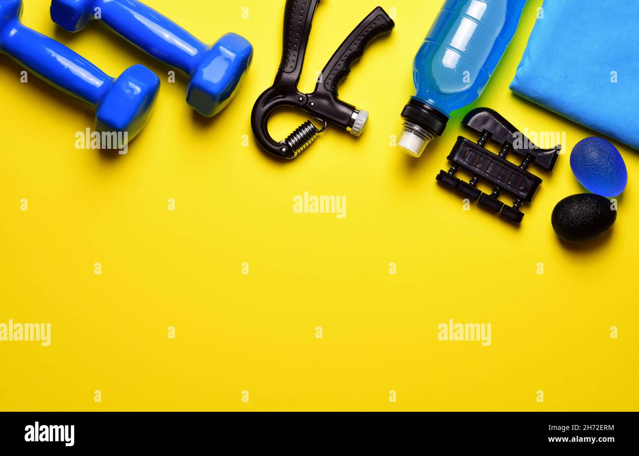 Top view of fitness tools. The bottle, hand and finger grips, and ...