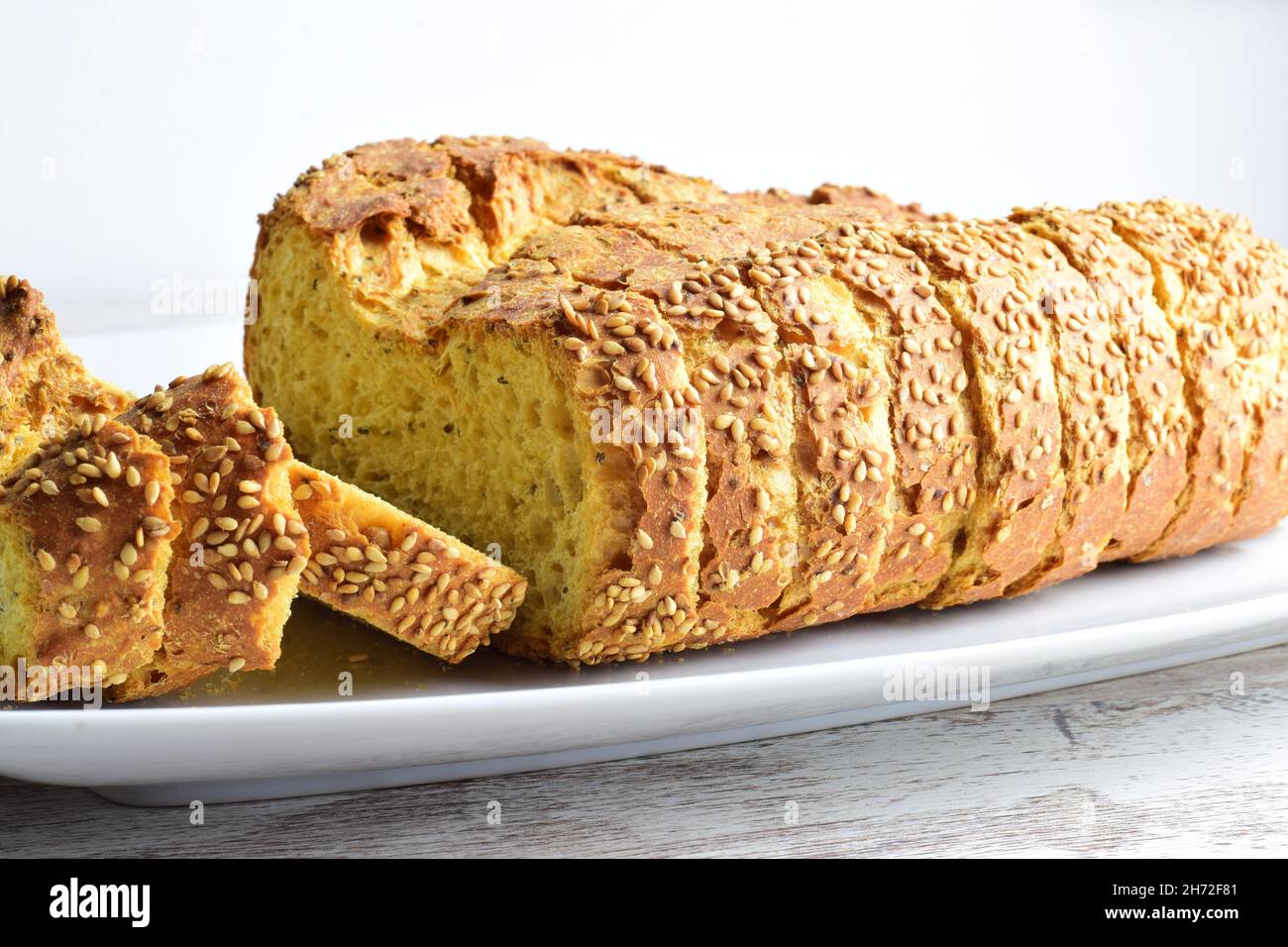 Closeup shot of bread with sesame on a white plate Stock Photo - Alamy