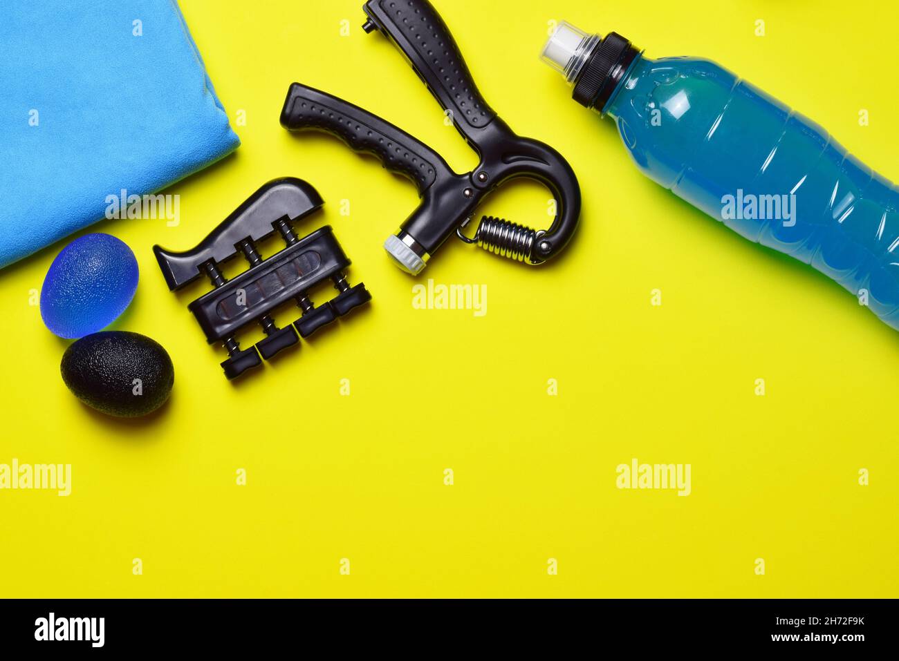 Top view of fitness tools. The water bottle, hand and finger grips ...