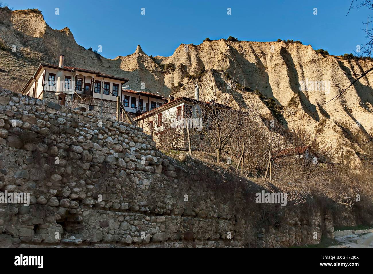 Old traditional houses against the backdrop of the famous sand pyramids ...