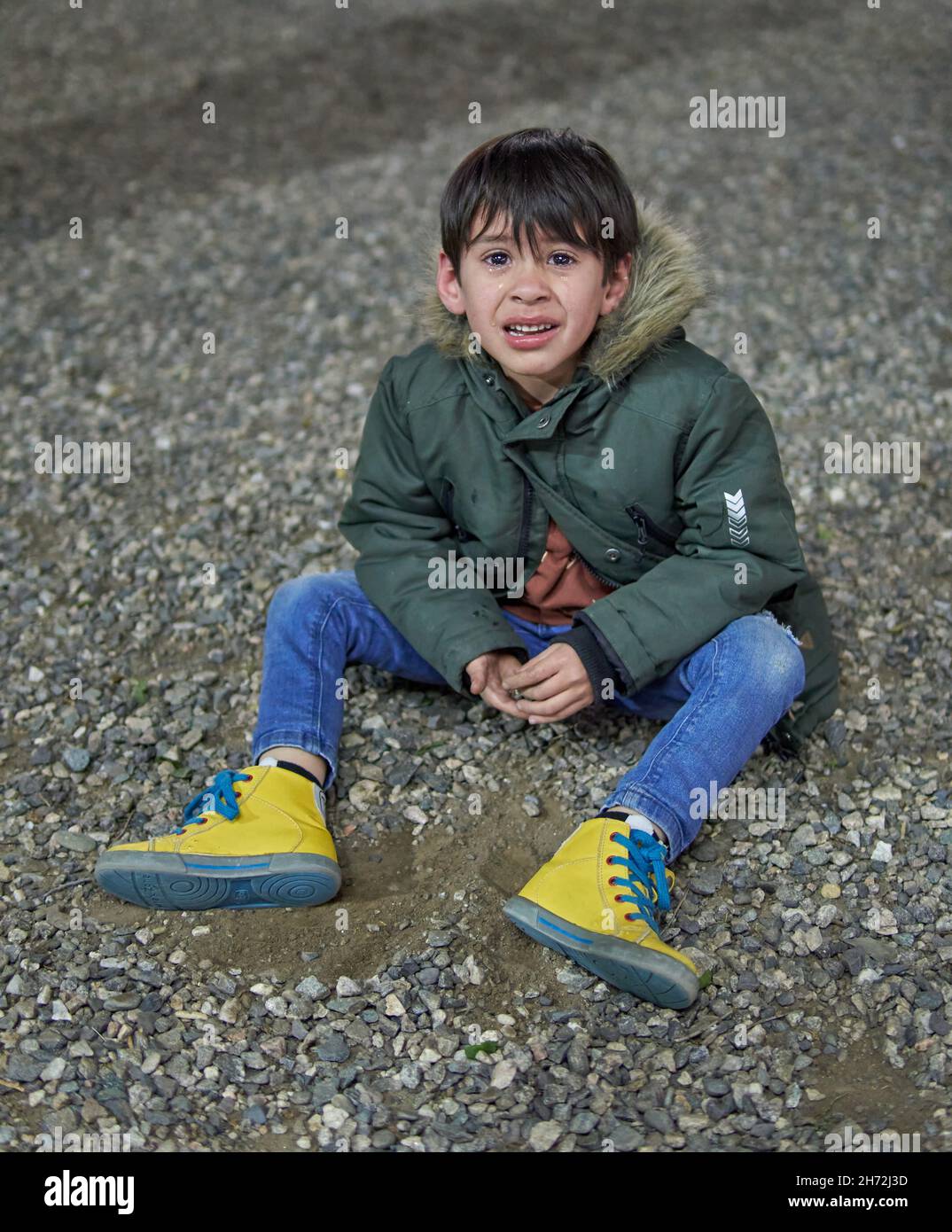 latino child staring at the camera with tears, very sad and anguished ...