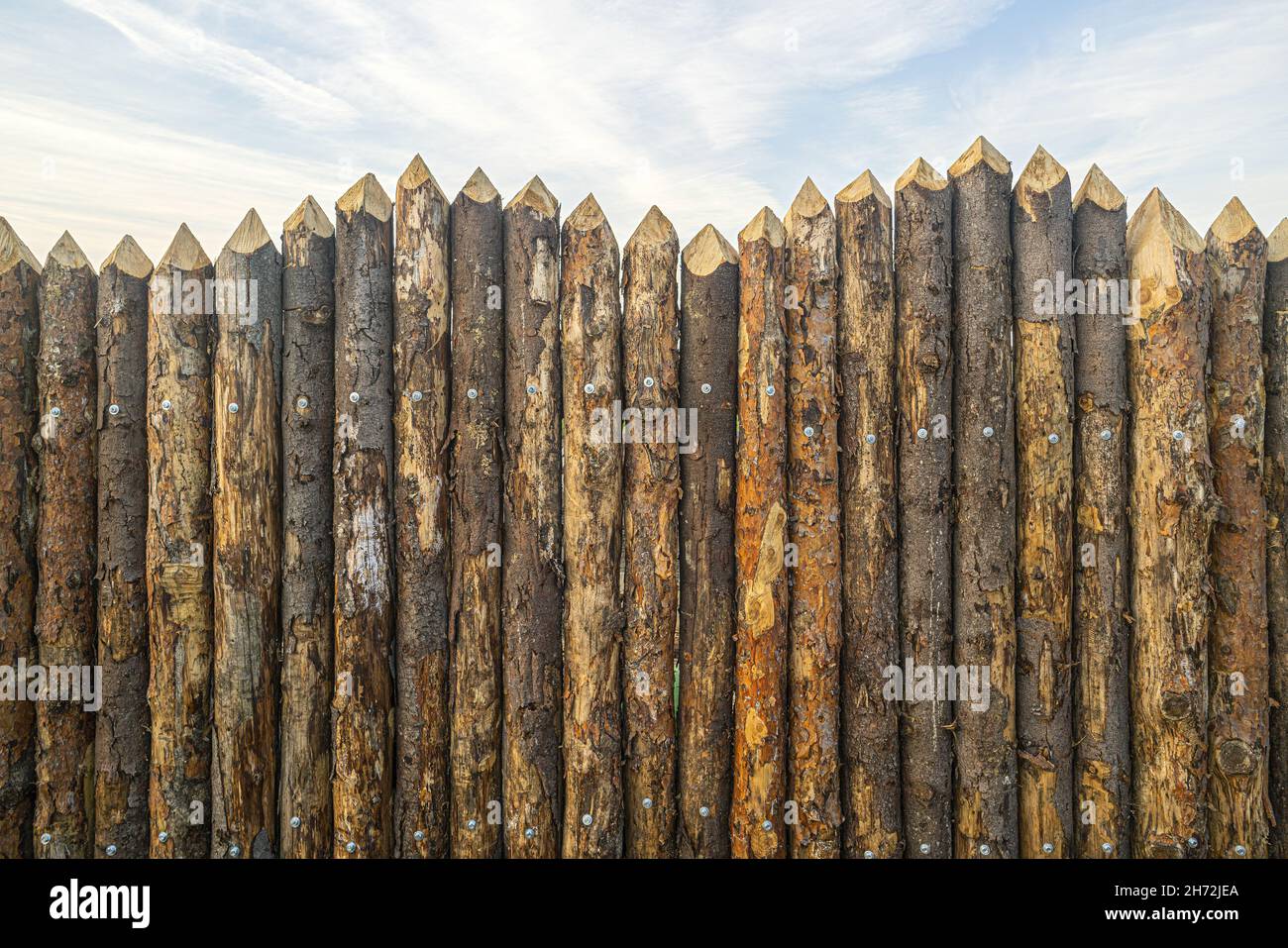 Wooden palisade made of logs Stock Photo - Alamy