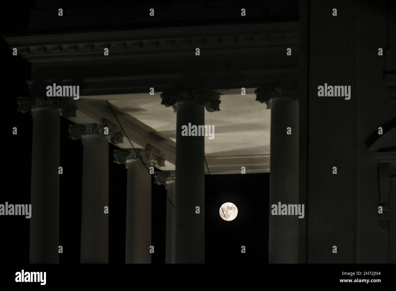 A full moon is seen through the columns of the North Portico of the ...