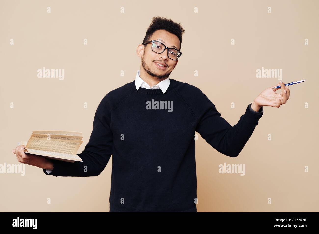 Young Professor holding a book while explaining wearing glasses on ...