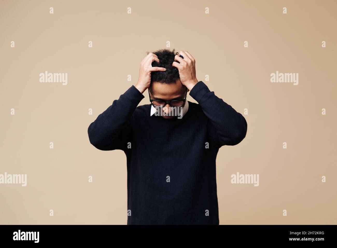Angry man. Afro man over beige background. Face expression. Crazy man ...