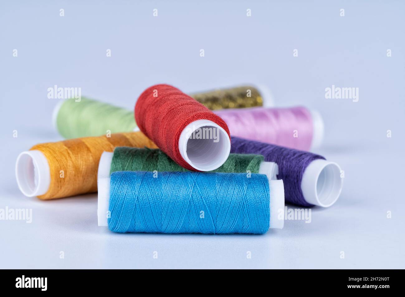 A Collection of sewing thread spools with threads of all colors Stock ...