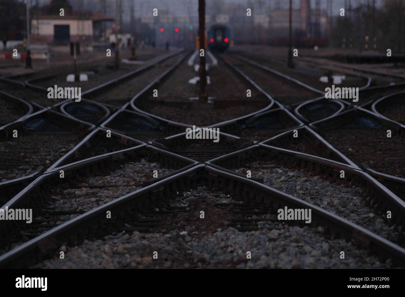 Crossing railway and a train on a background on a dark evening Stock ...