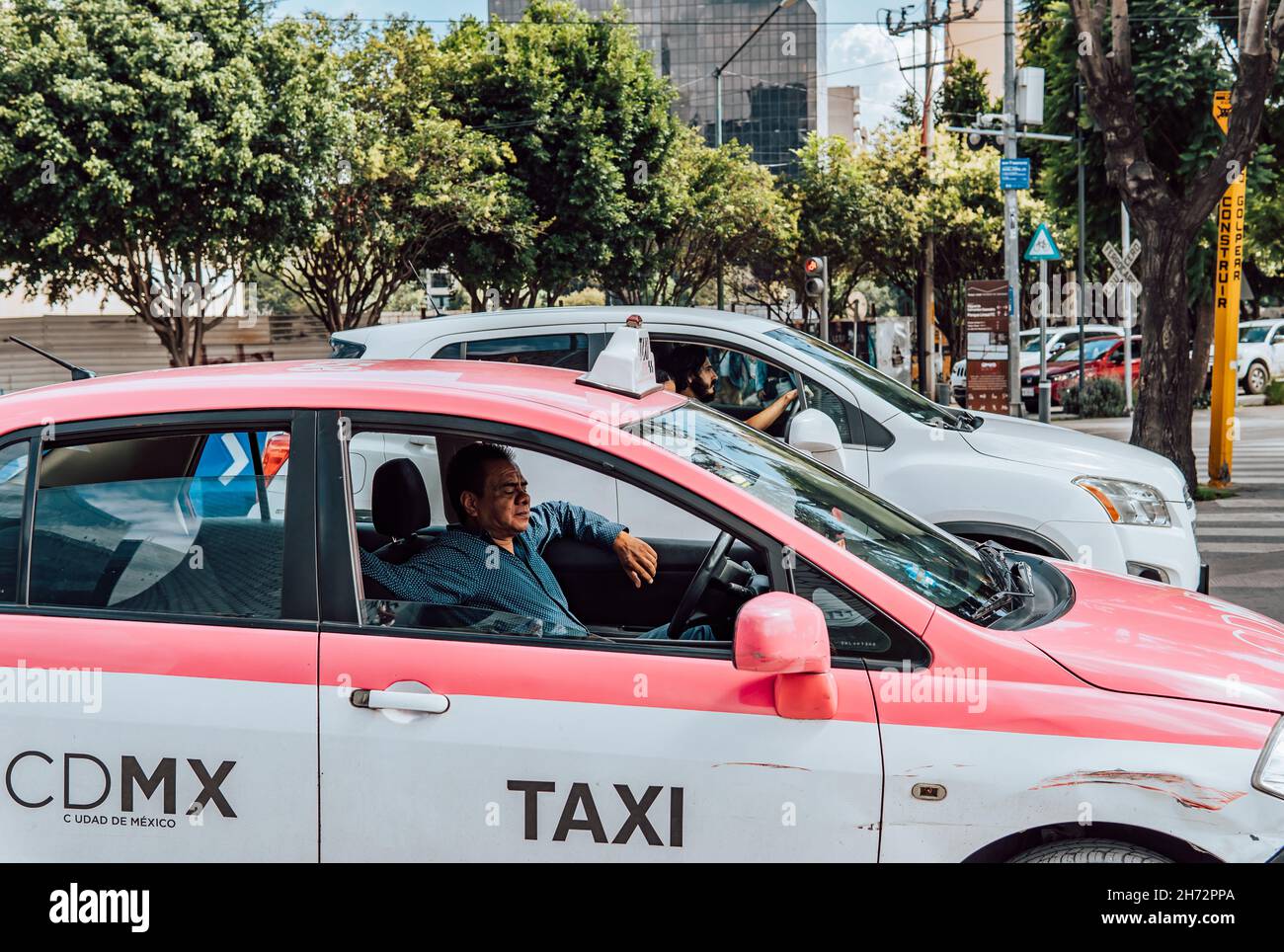 MEXICO CITY, MEXICO - Aug 23, 2021: A taxi driver inside his taxi on a ...
