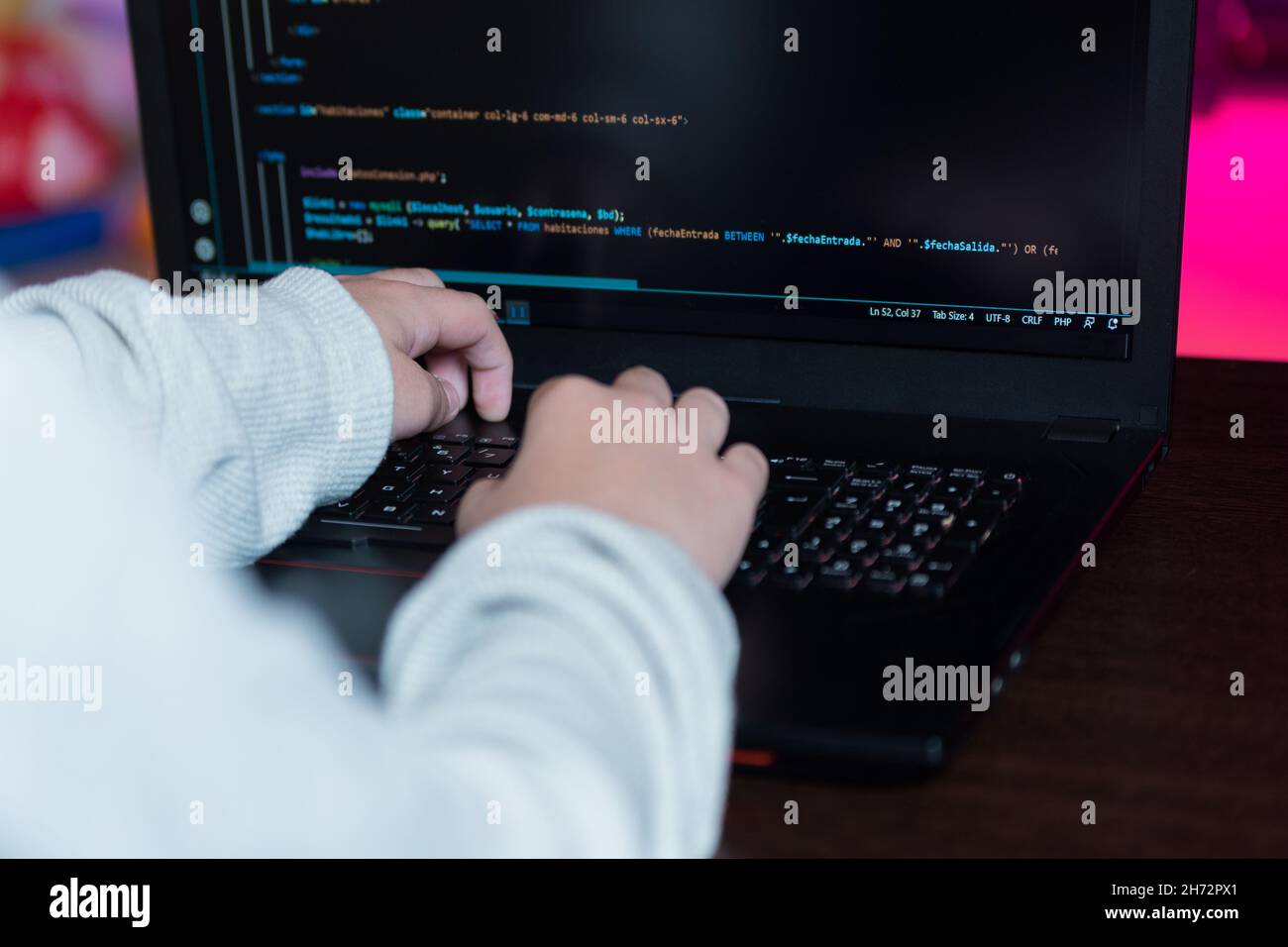 Teenager writing code programming a web page to do her homework as a ...