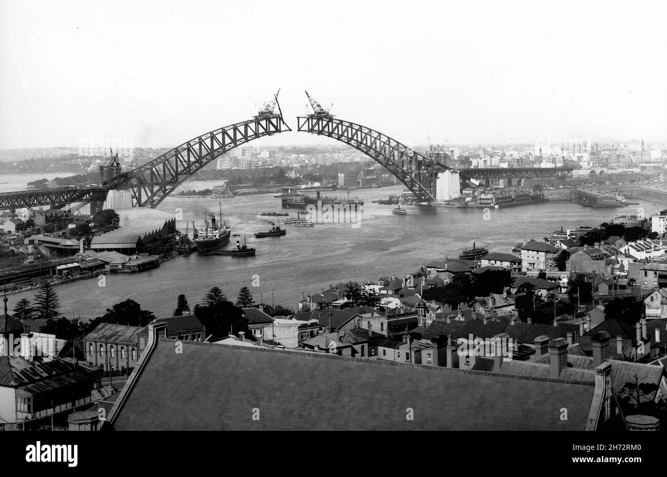 Historical Sydney Harbour Bridge under construction over Sydney harbour ...