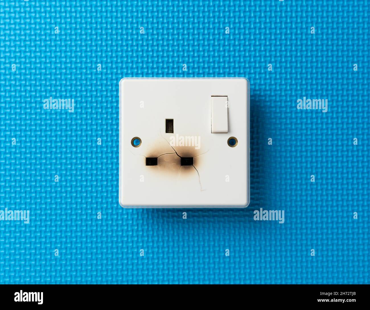 Damaged electrical domestic power socket with cracks and burn marks on ...