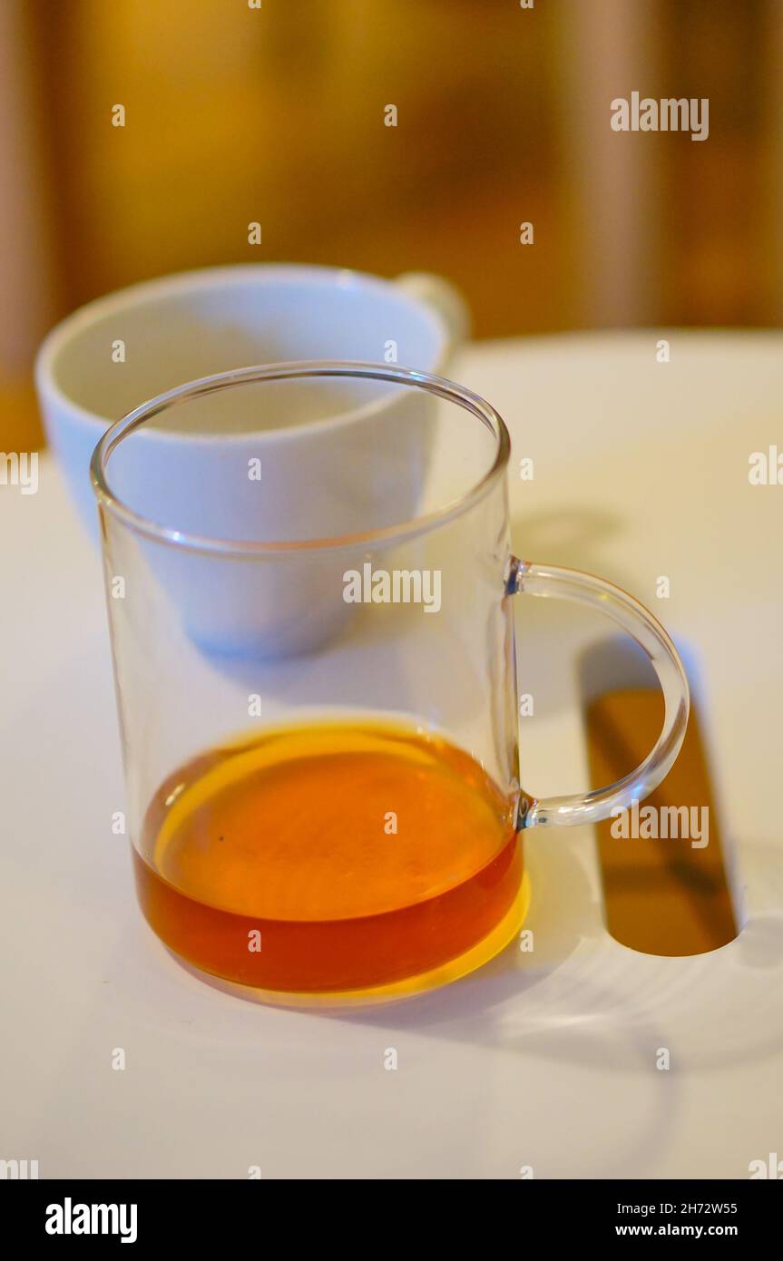 Vertical shot of a glass with the remnants of unfinished tea Stock ...