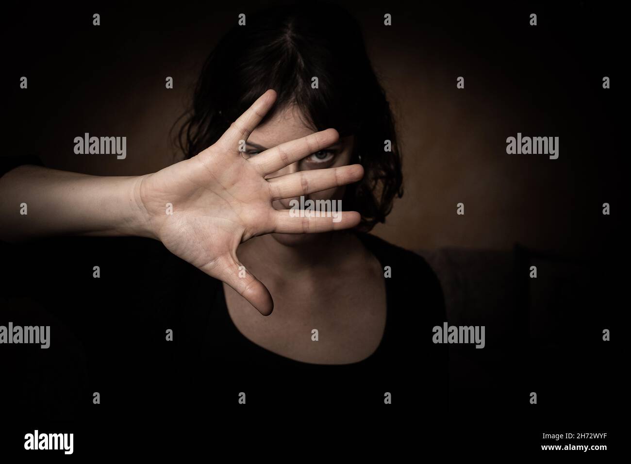Woman hiding her face by showing stop sign Stock Photo - Alamy