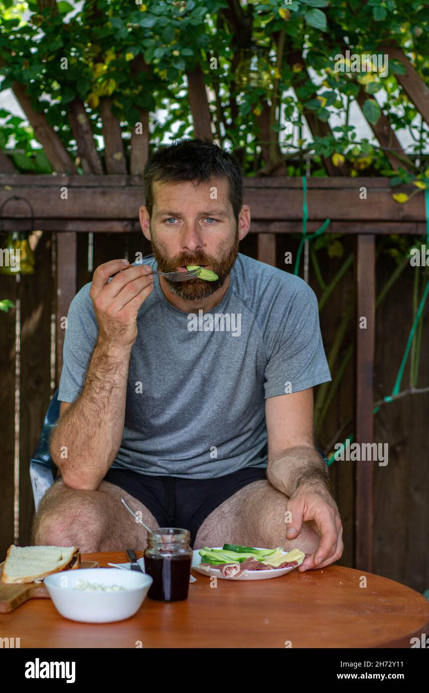 young man eating breakfast Stock Photo - Alamy