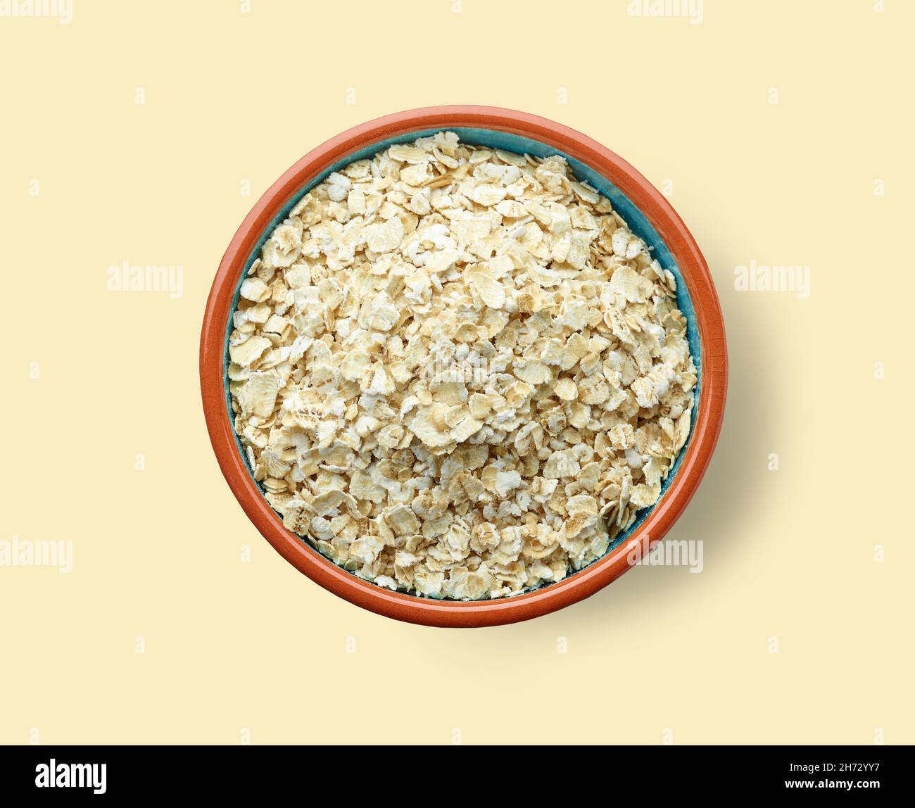 bowl of oat flakes on beige color background, top view Stock Photo - Alamy