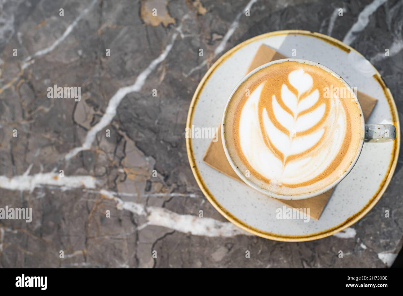 Cappuccino white coffee cup with heart shape art. Marble table. Top ...
