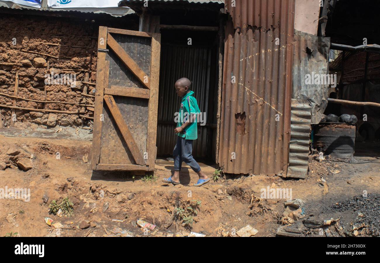 A young boy walks past a local community public toilet in Kibera.World ...