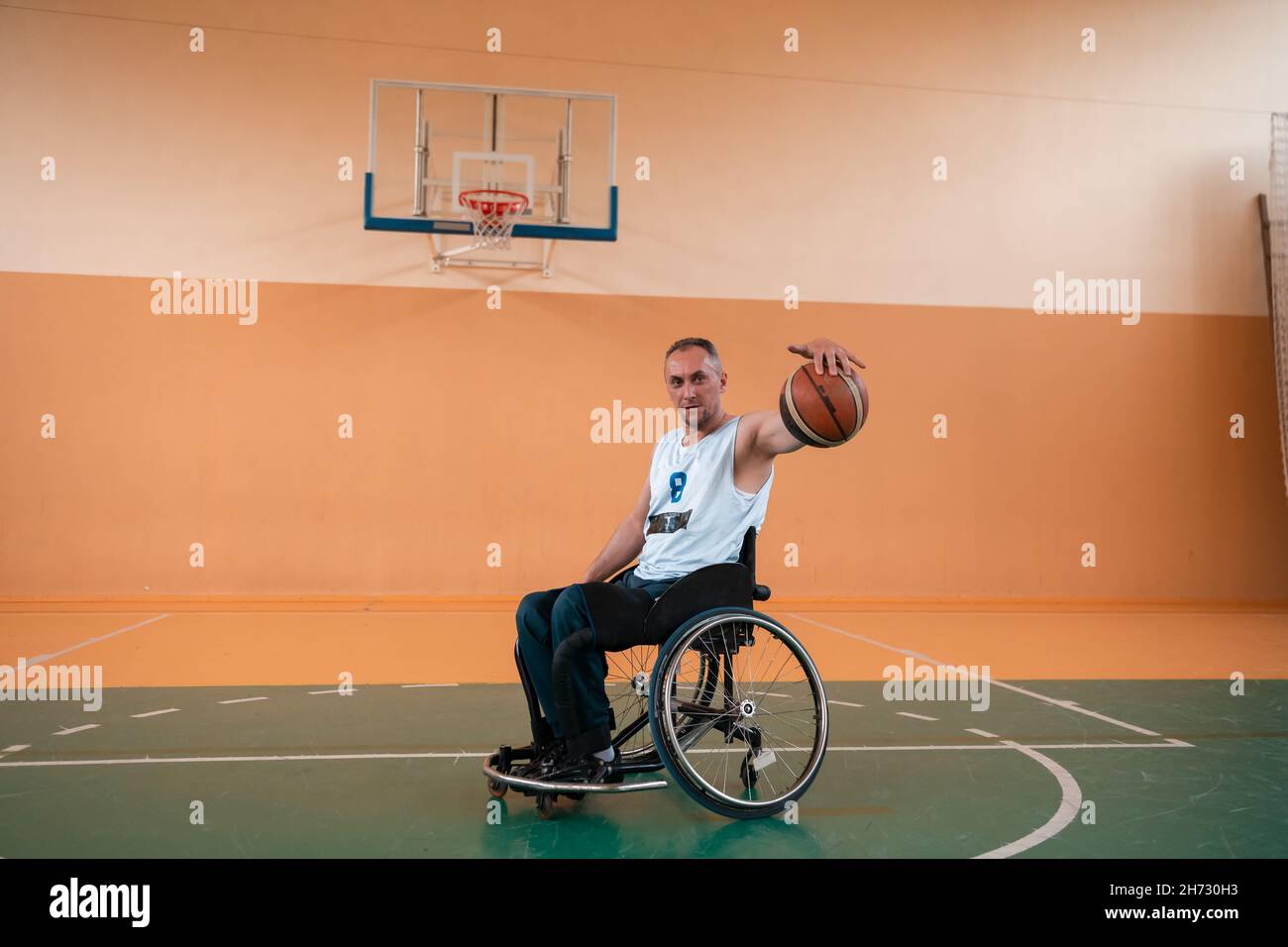 a photo of a war veteran playing basketball in a modern sports arena ...